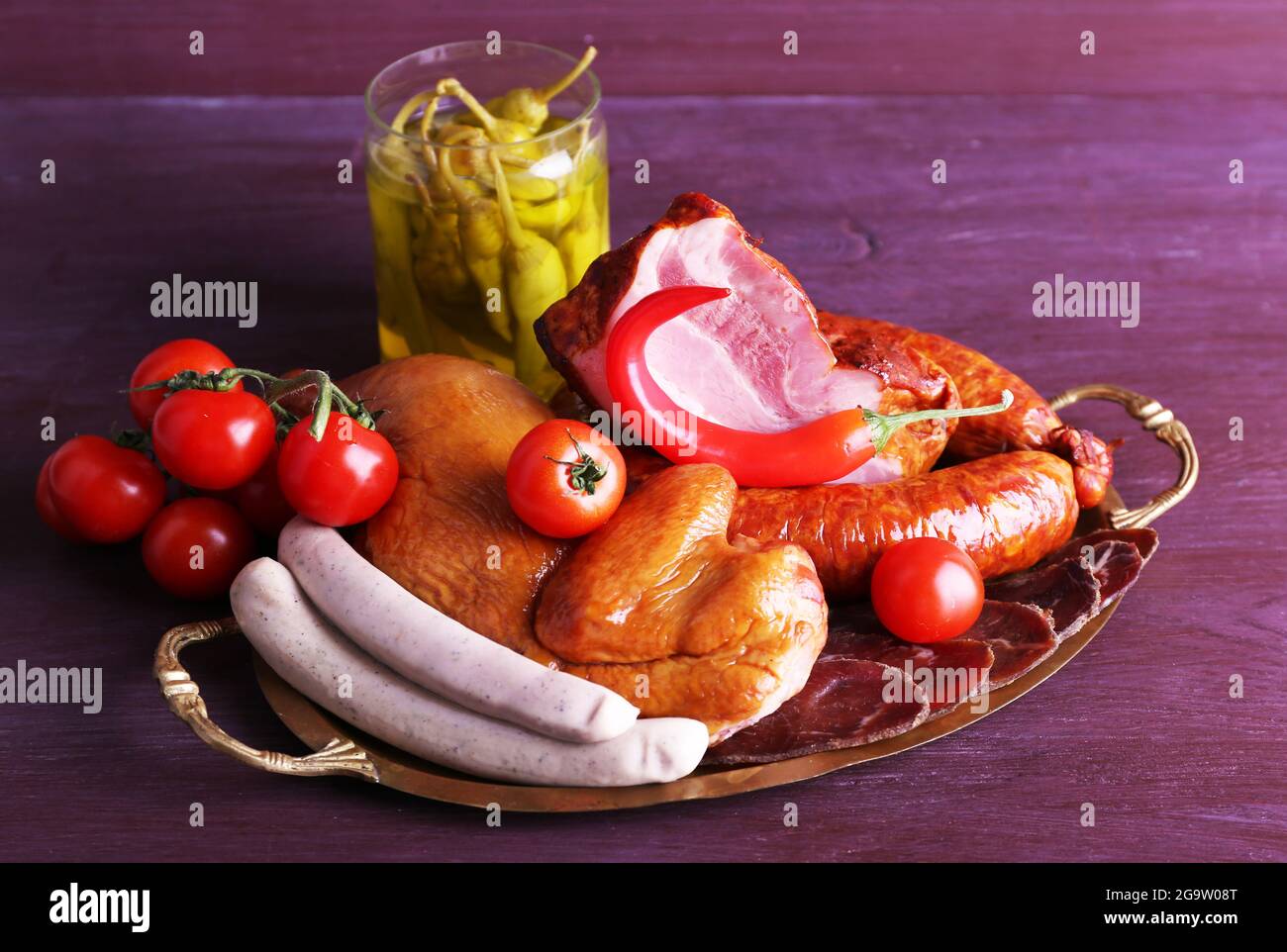 Assortment of deli meats on metal tray on color wooden background Stock ...