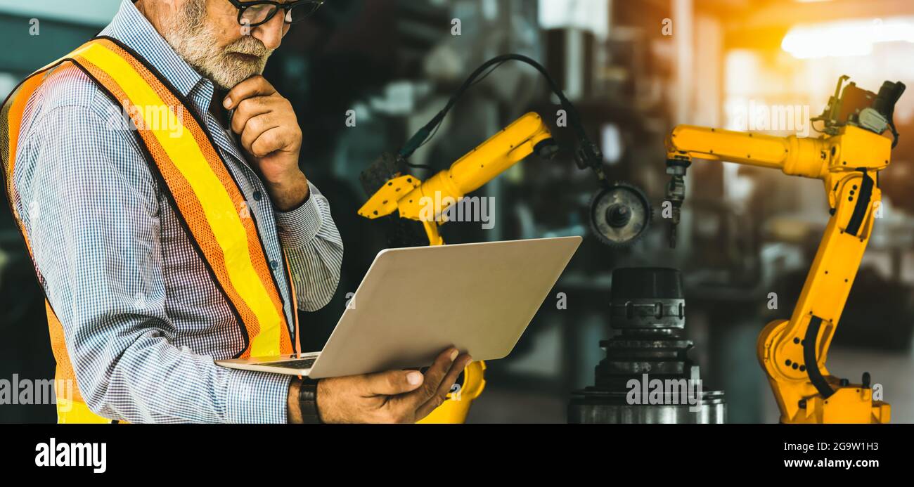 Engineer use advanced robotic software to control industry robot arm in ...