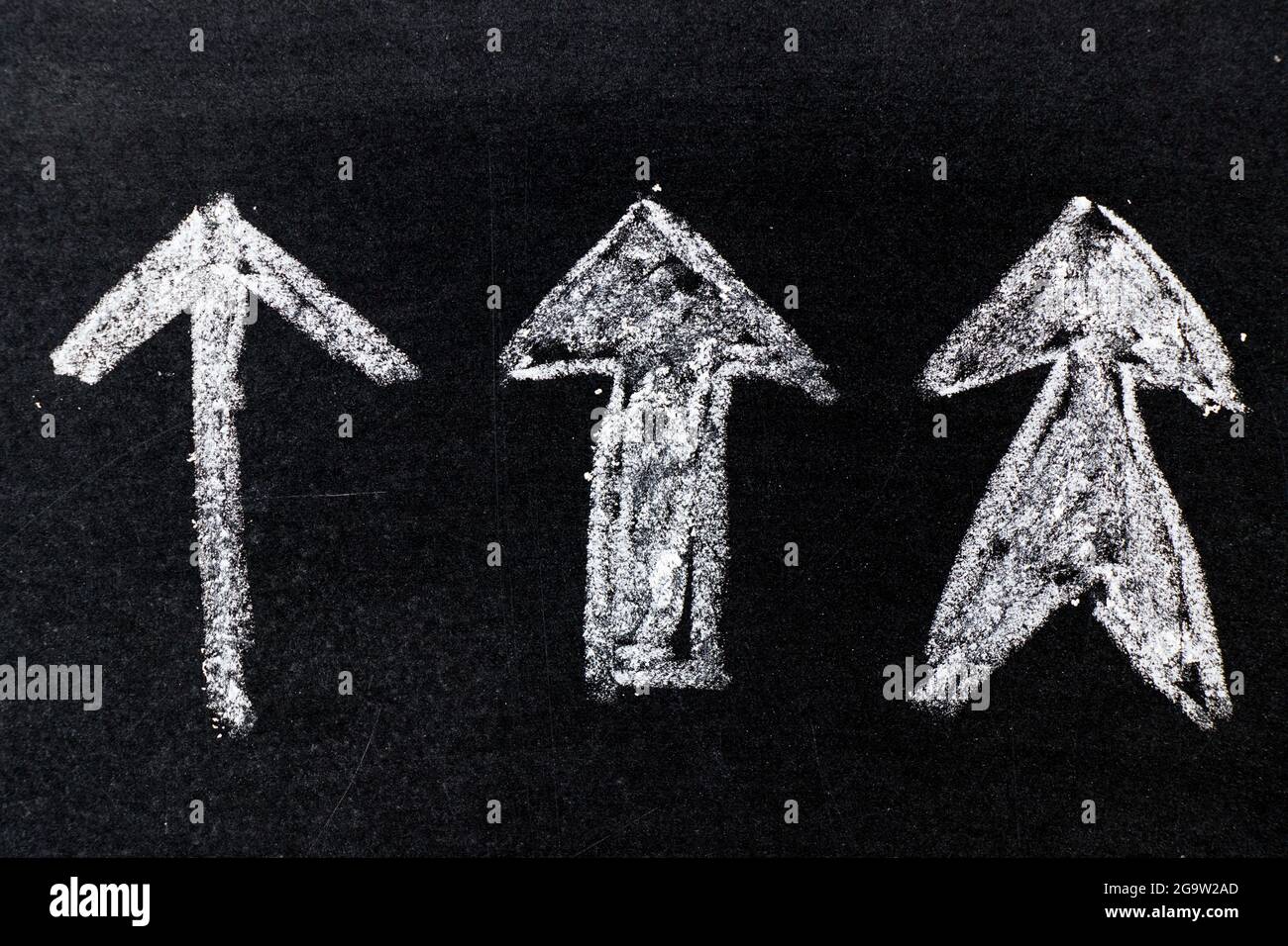 White chalk drawing in arrow shape on black board background Stock ...