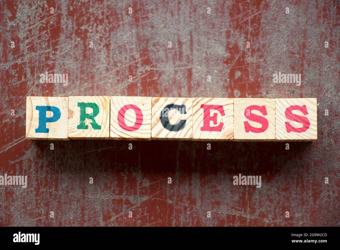 Letter block in word process on old red wood background Stock Photo - Alamy