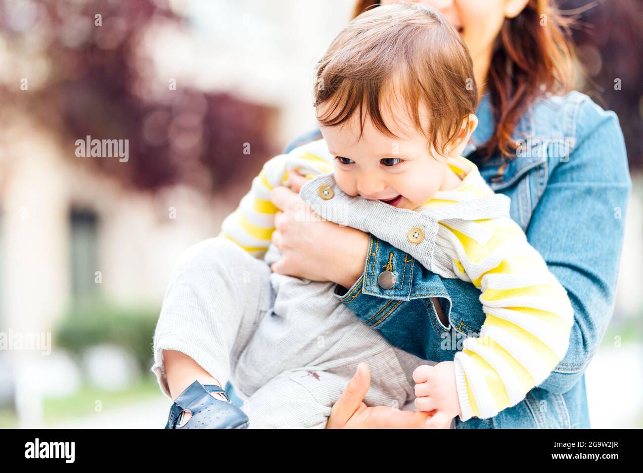 happy one year old baby grabbed by his mother Stock Photo - Alamy