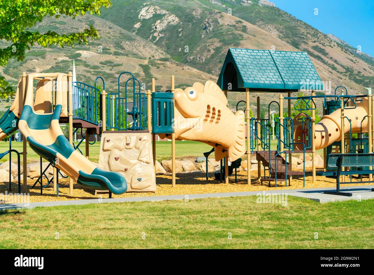 Jungle gym with slides in a children's playground outdoors with a large ...