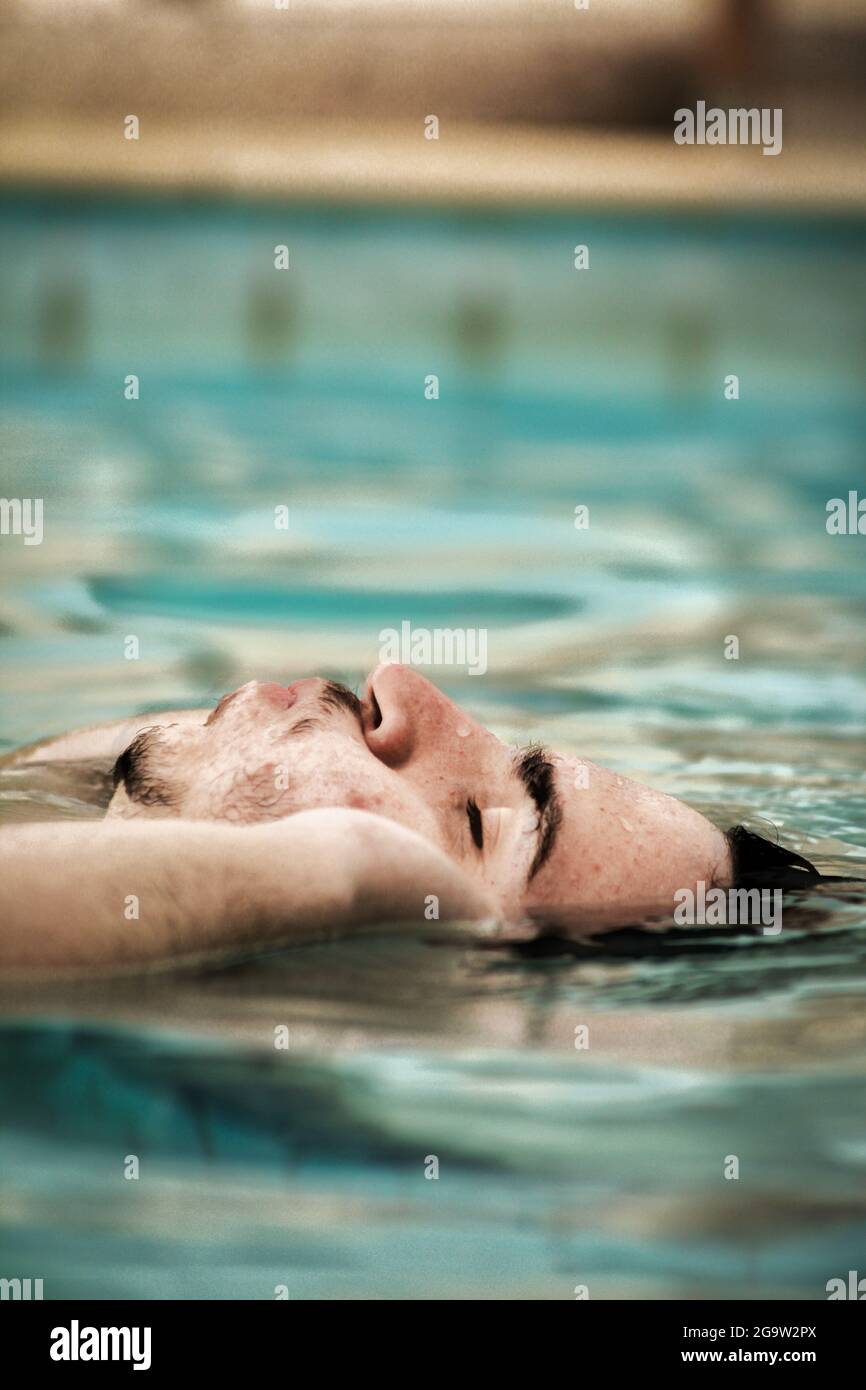 Vertical shot of a Native American guy coming out of a swimming pool ...