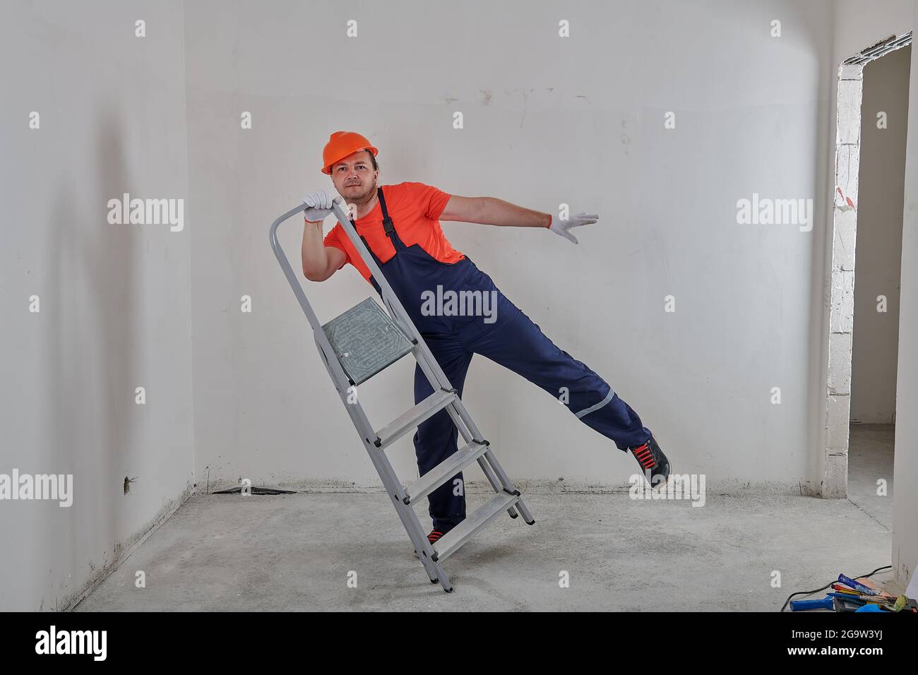 one repairman in a bright cap makes repairs Stock Photo - Alamy