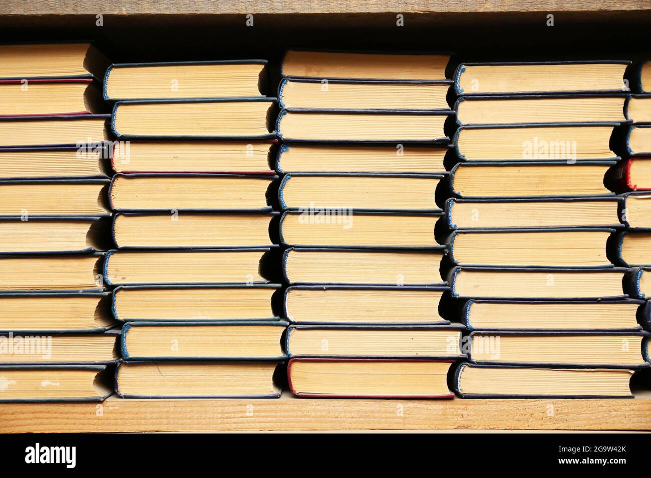 Stack of books in library Stock Photo - Alamy