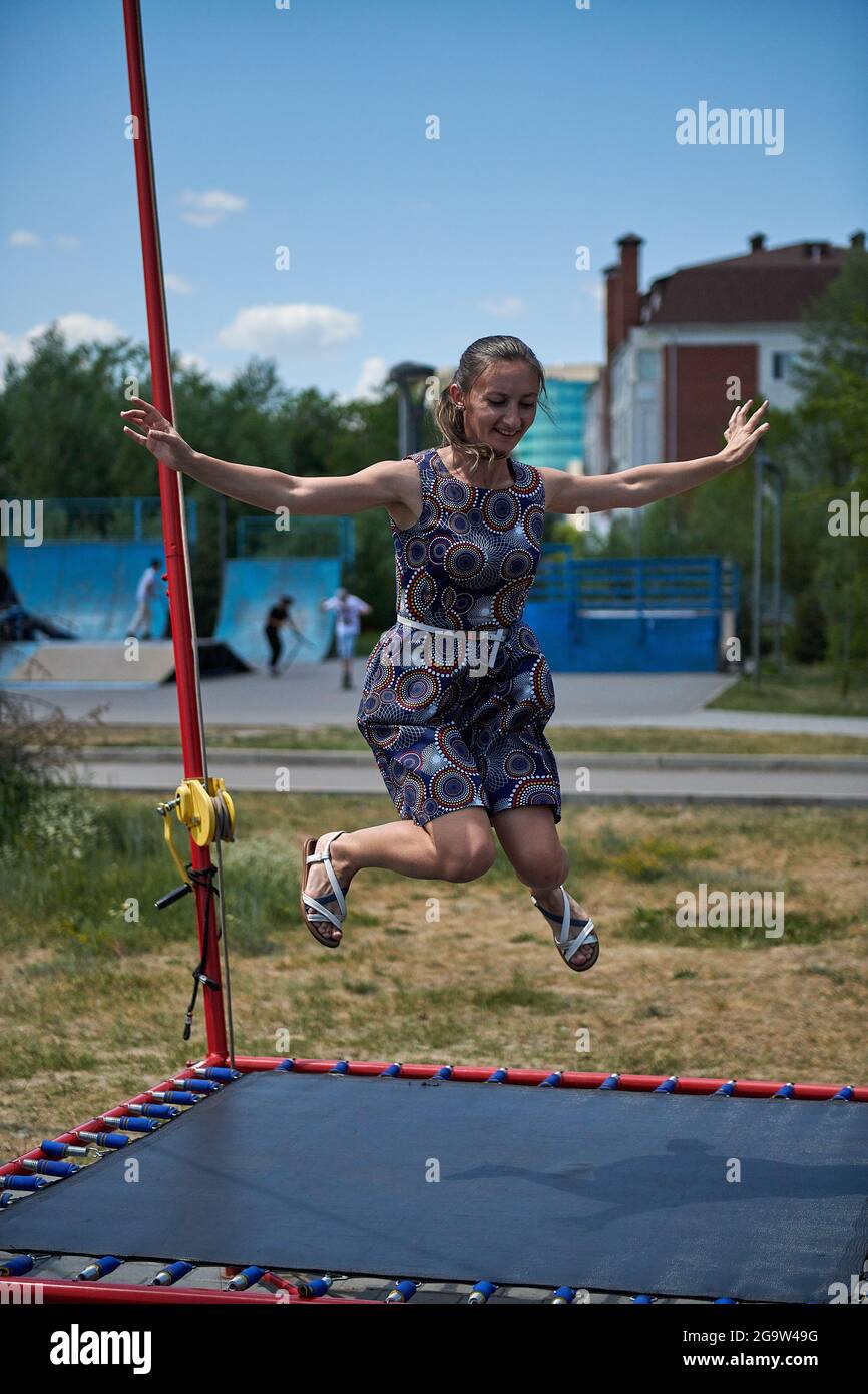 big man jumping on a trampoline in summer Stock Photo - Alamy