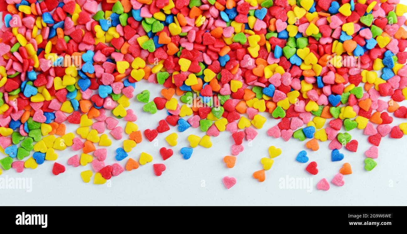 Colorful sprinkles on white background Stock Photo - Alamy