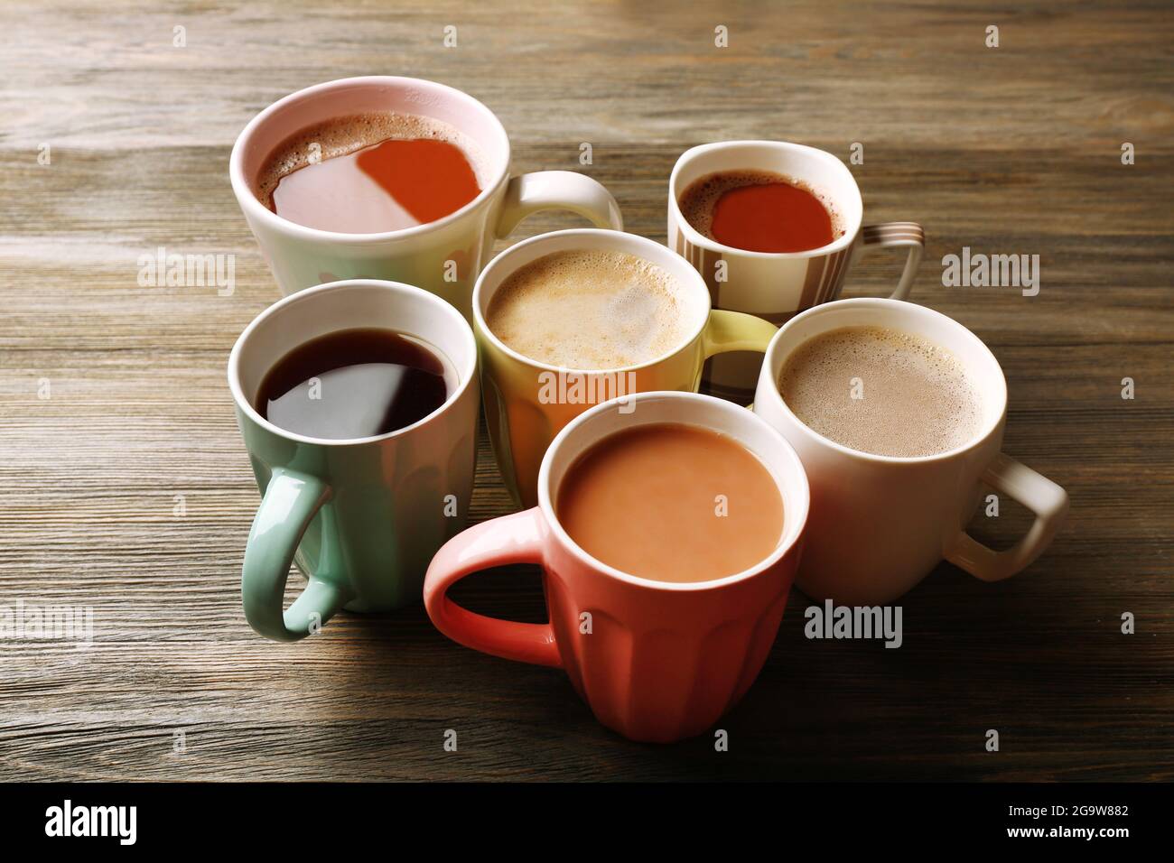 Many cups of coffee on wooden table background Stock Photo - Alamy