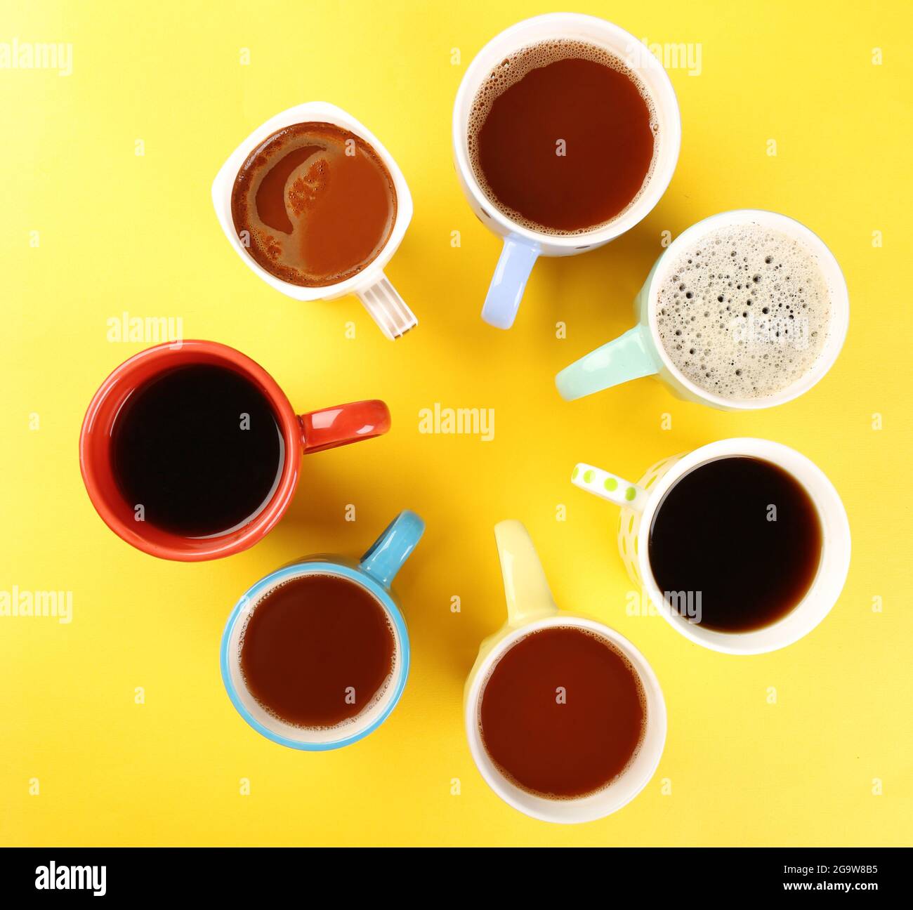 Many cups of coffee on yellow background Stock Photo - Alamy