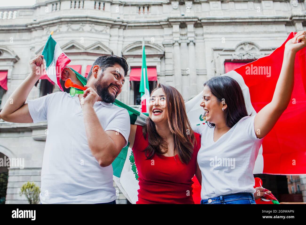 Mexican soccer fans with mexican flag celebrating outdoors in Mexico ...