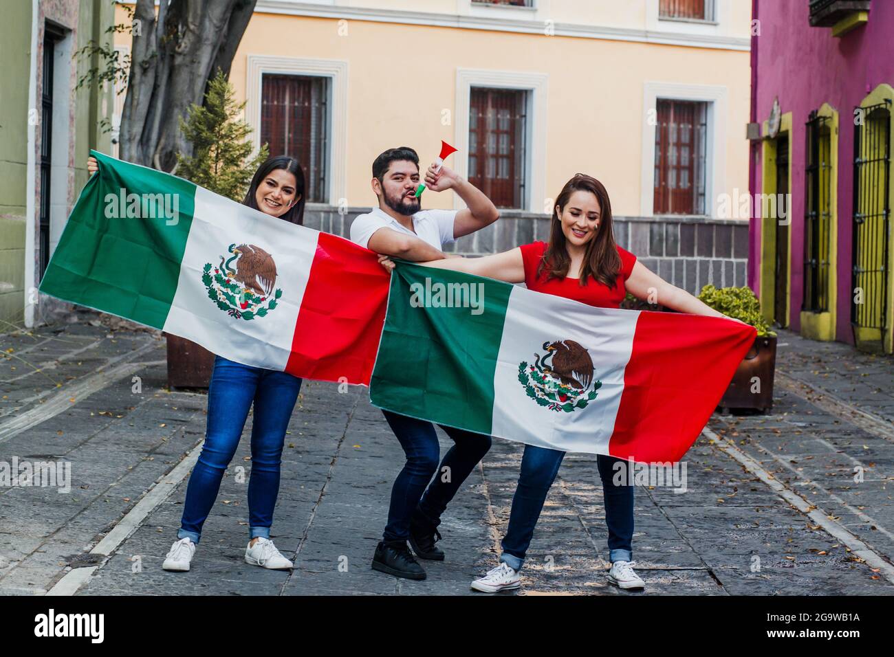 Young mexican soccer fans holding flags in Mexico Stock Photo - Alamy