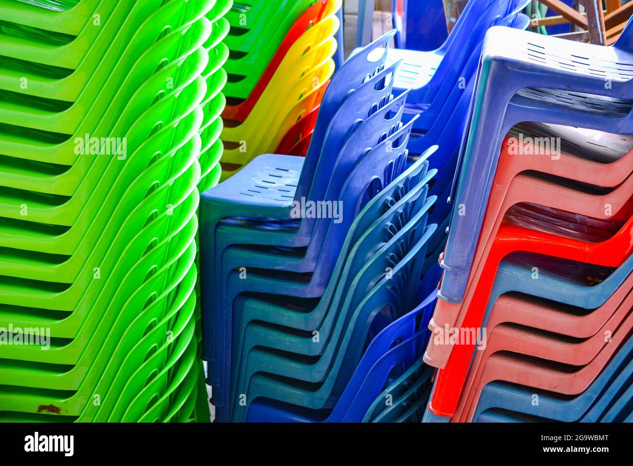 Stacked Colorful Plastic Chairs. Plastic Products Stock Photo - Alamy