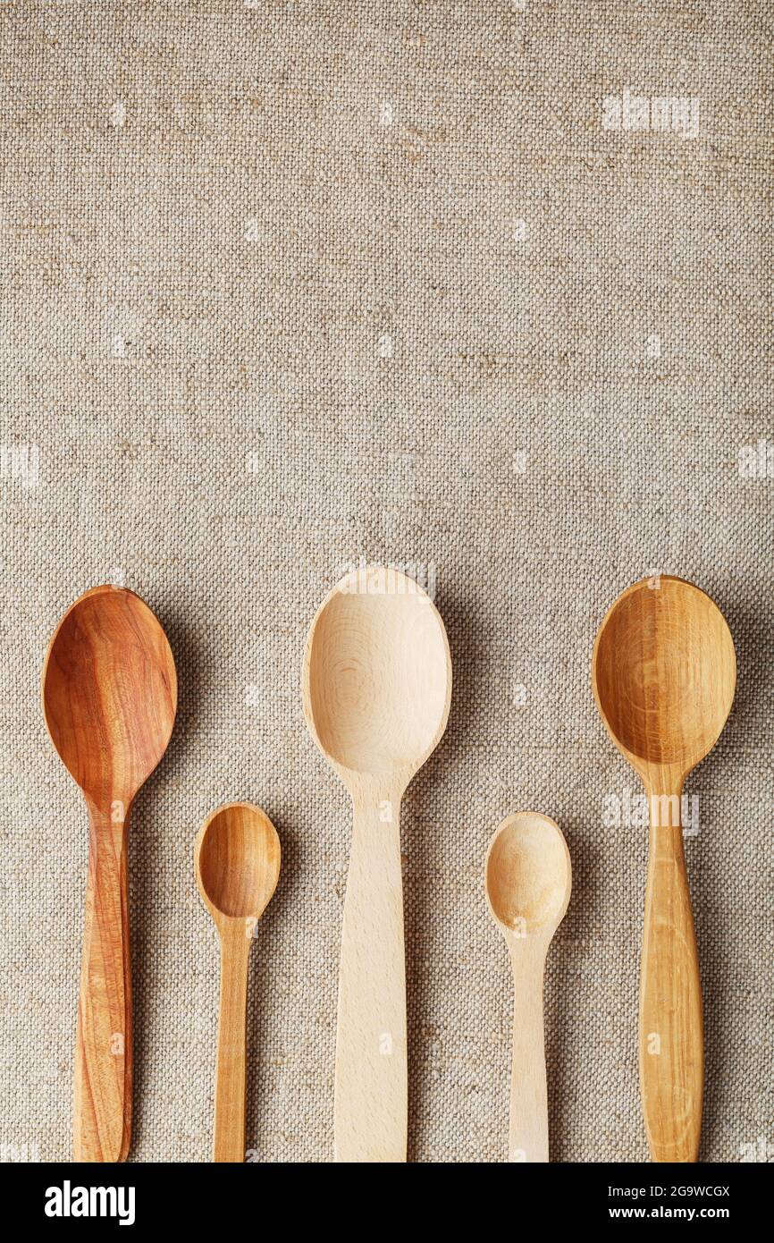 Wooden spoons made of natural wood on burlap fabric as a craft. Natural ...
