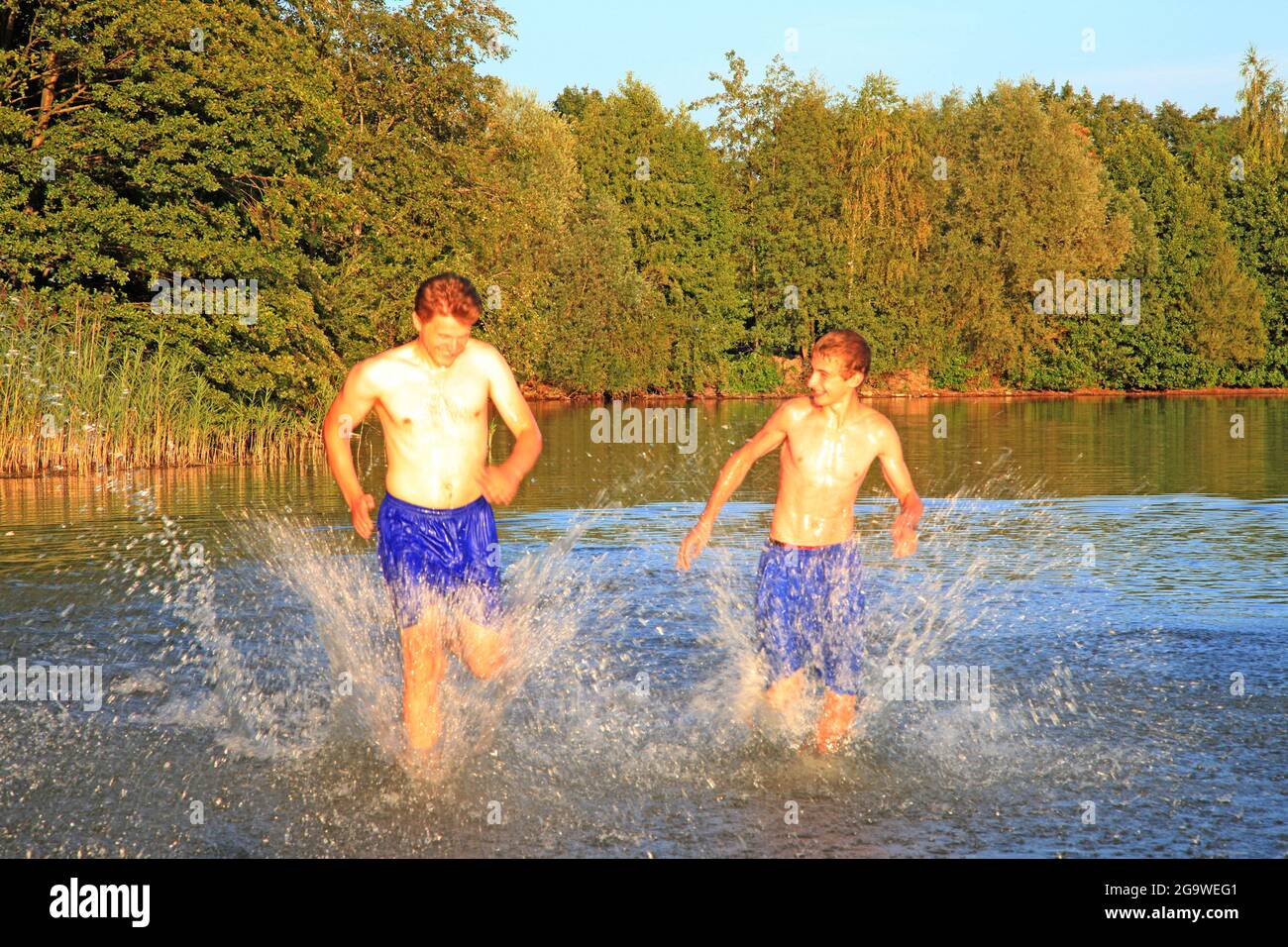 Group of young people playing games on sandy beach on a summer day ...