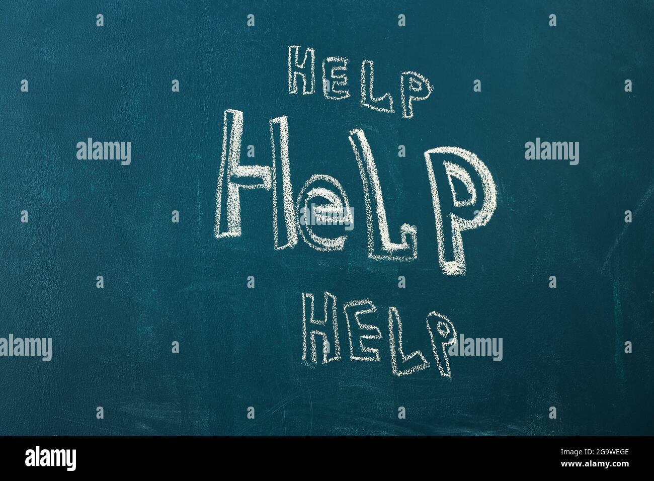 Help written with chalk on blackboard Stock Photo - Alamy