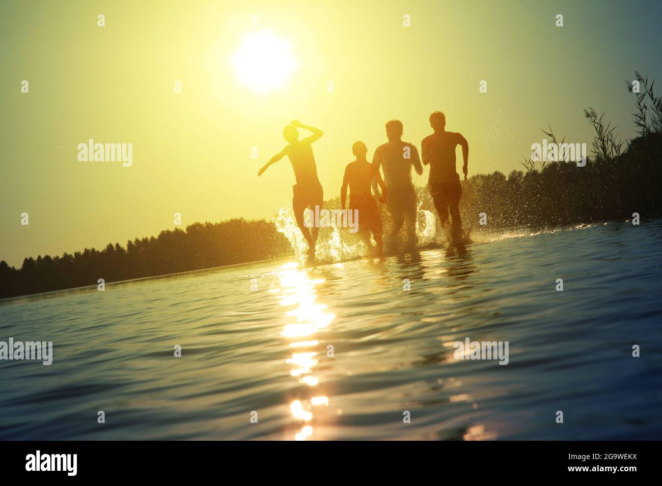Group of young people playing games on sandy beach on a summer day ...