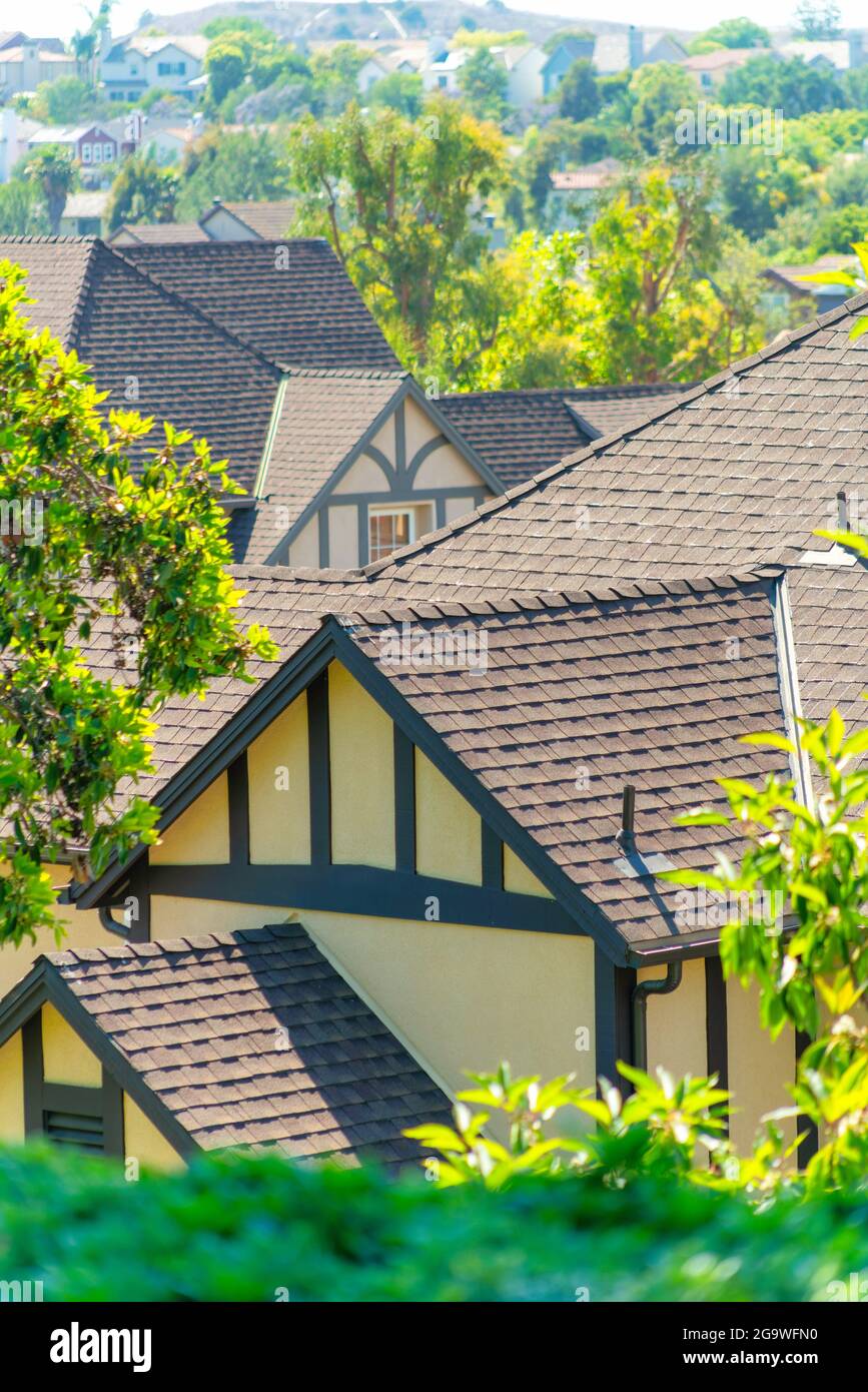 Vertical shot of brown tile roofs of houses in a rural town with ...