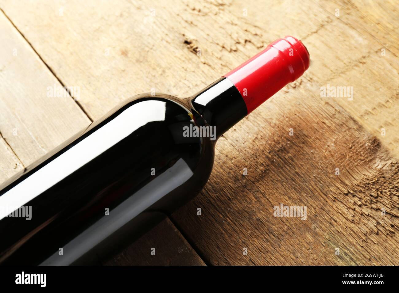 Glass bottle of wine on wooden table background Stock Photo - Alamy