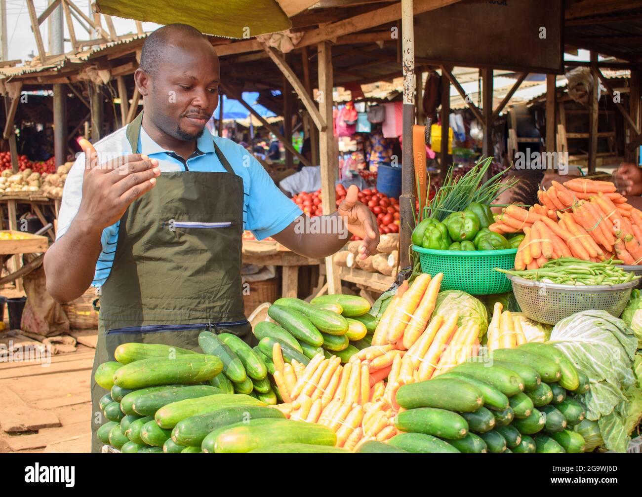 stock photo of male African grocery seller or business man with apron ...