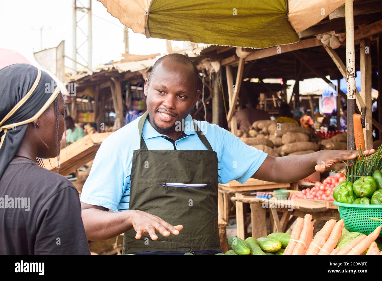 stock photo of male African grocery seller or business man with apron ...