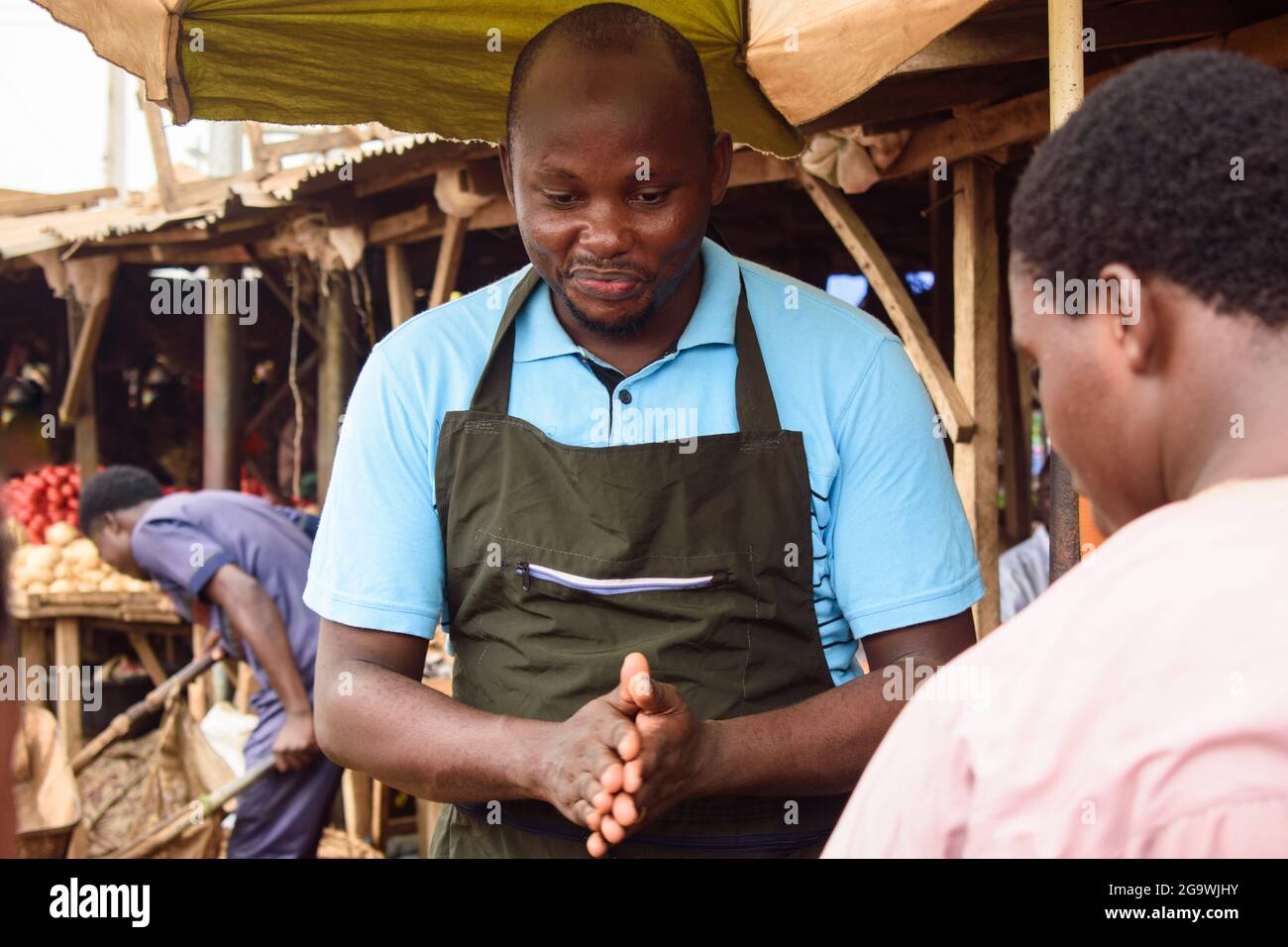 stock photo of male African grocery seller or business man with apron ...