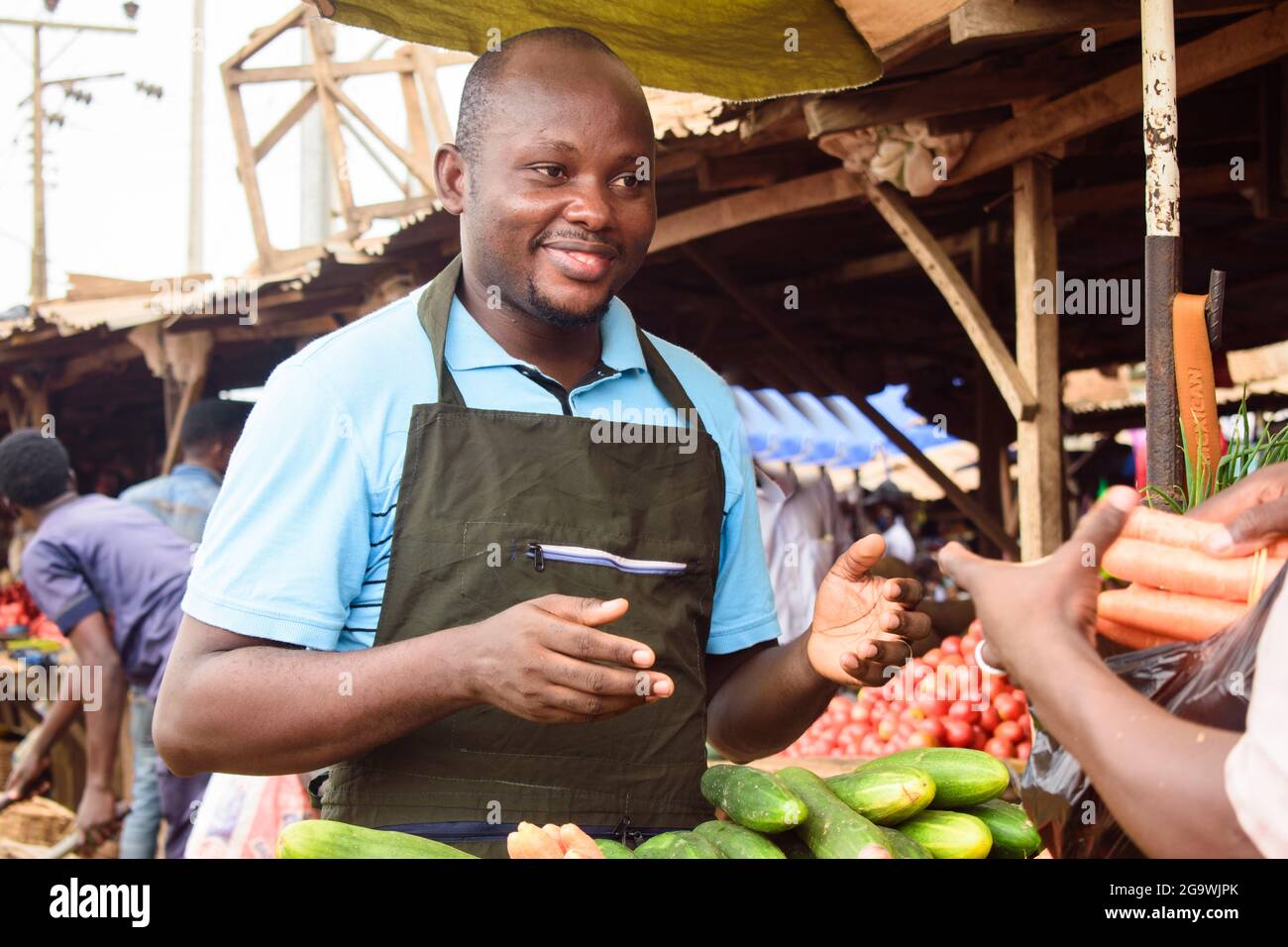 stock photo of male African grocery seller or business man with apron ...