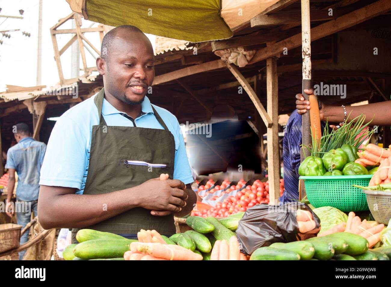 stock photo of male African grocery seller or business man with apron ...