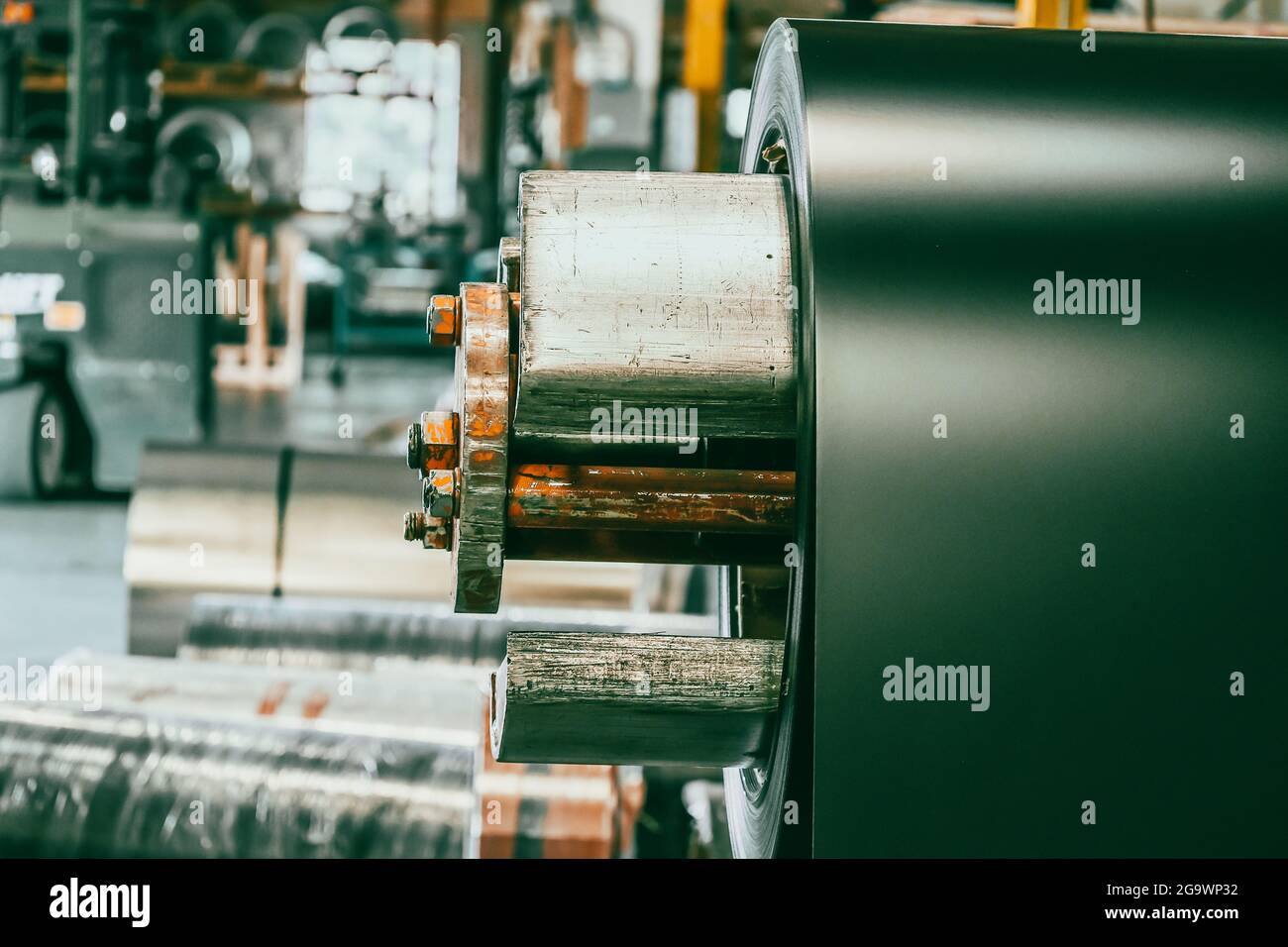 Metal coil on machine in metal roofing factory Stock Photo - Alamy