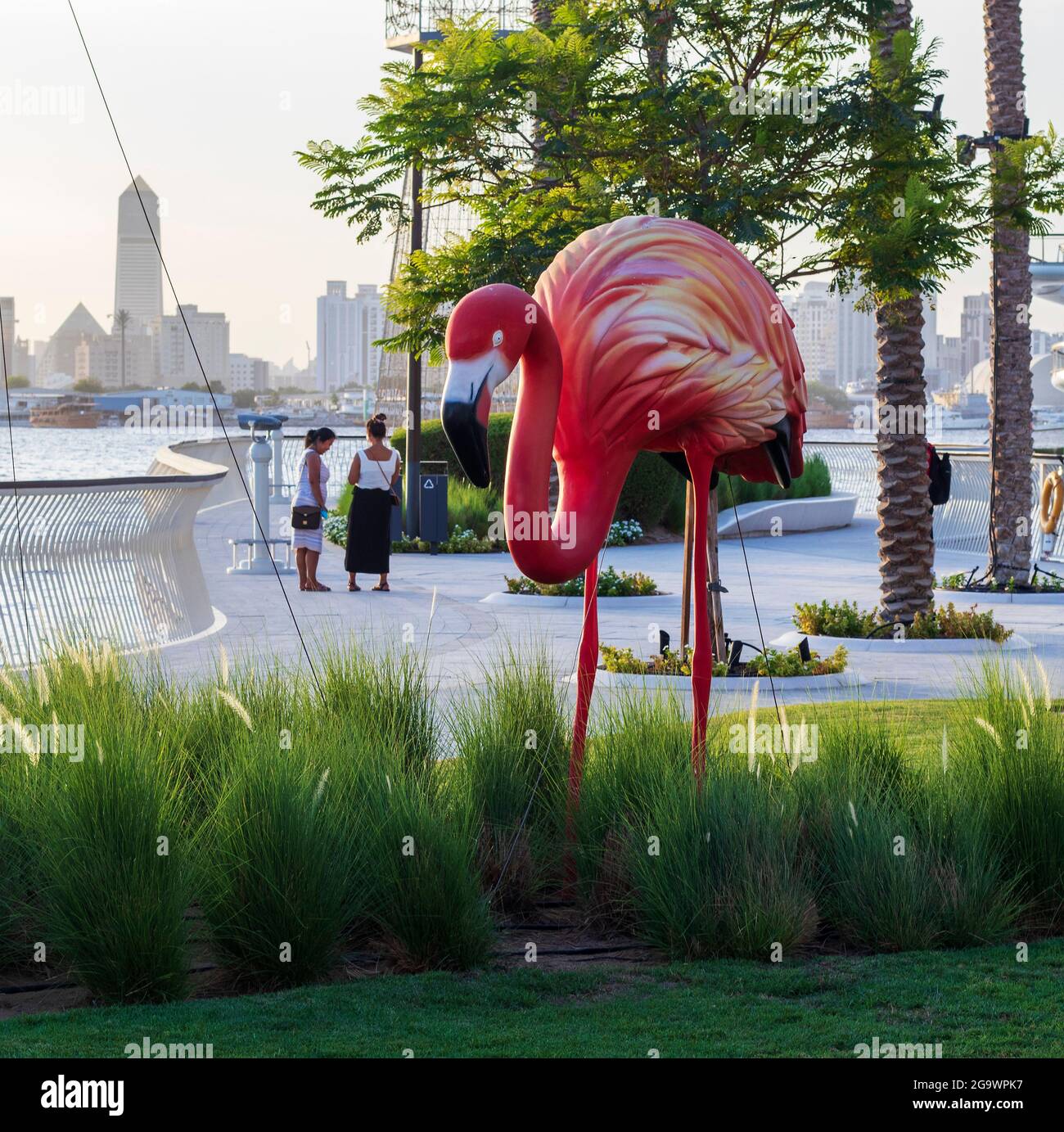 Dubai, UAE - 07.17.2021 Visitors close by flamingo installations at ...