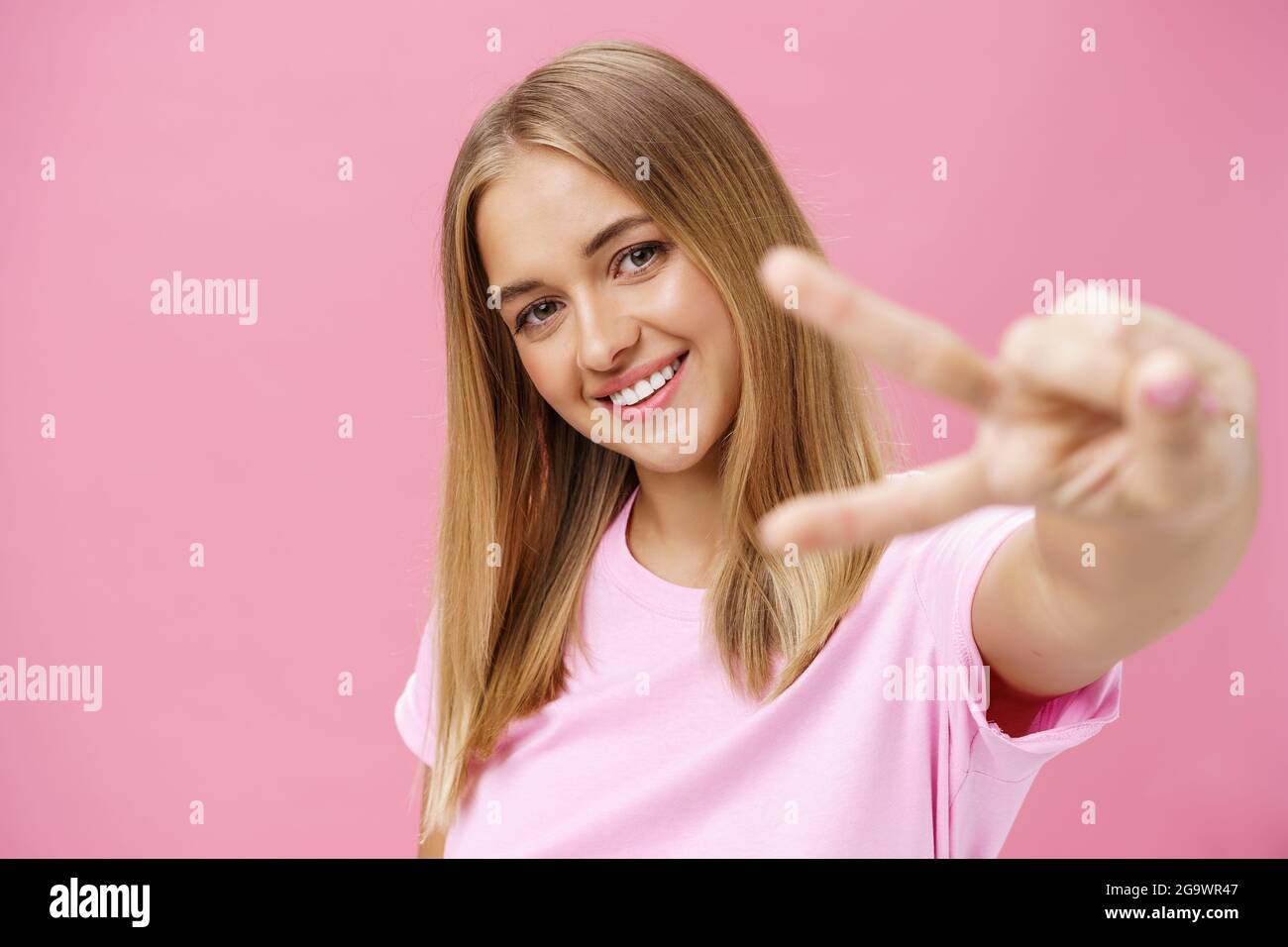 Peaceful and joyful good-looking young girl with straight blond hair in ...