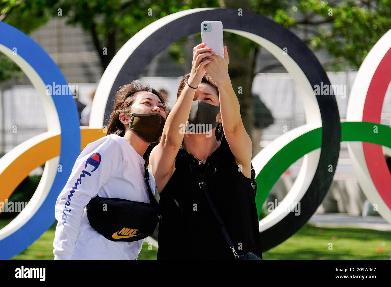 Tokyo, Japan. 15th July, 2021. People wearing face masks take a selfie ...