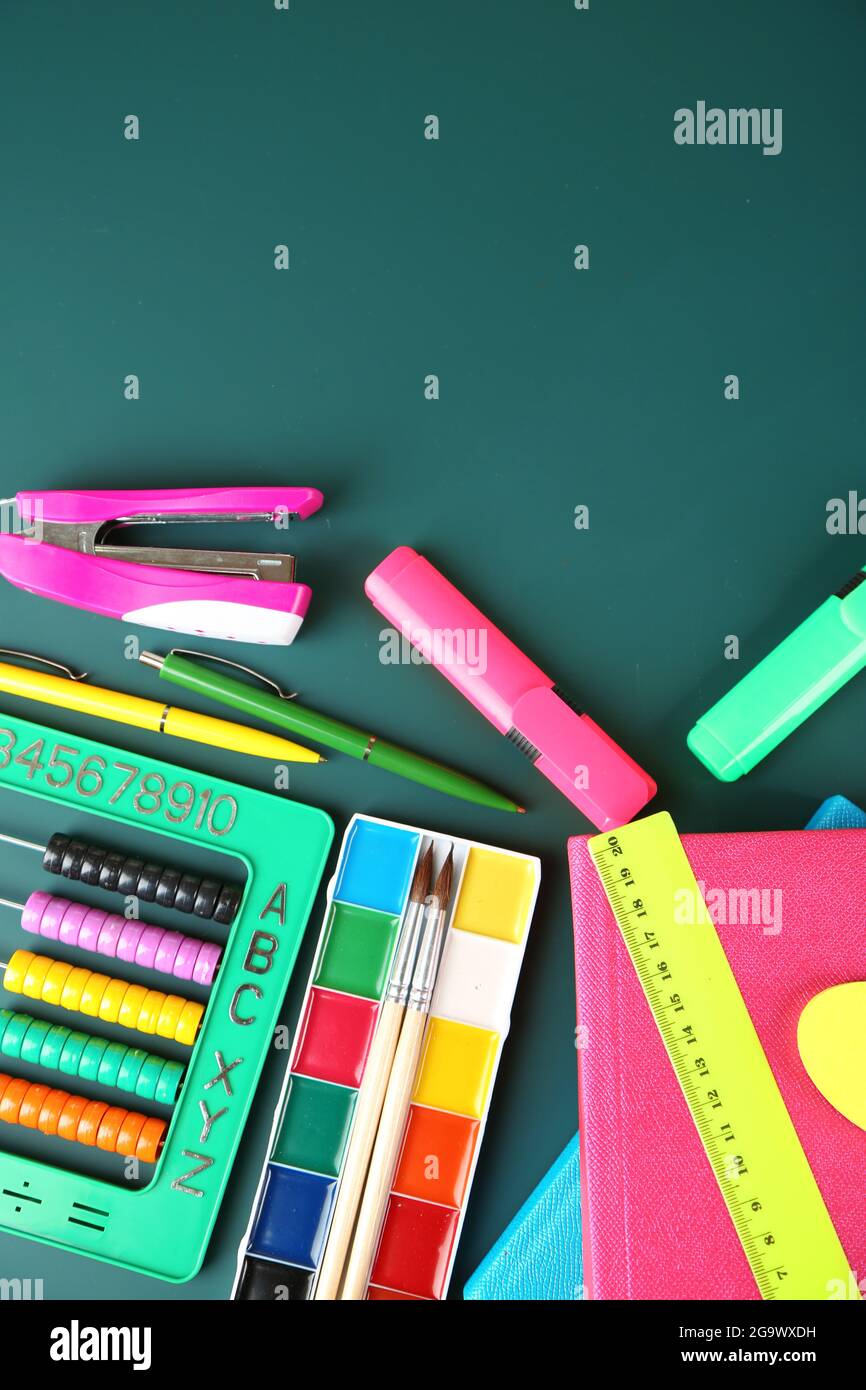 Bright school supplies on blackboard background Stock Photo - Alamy