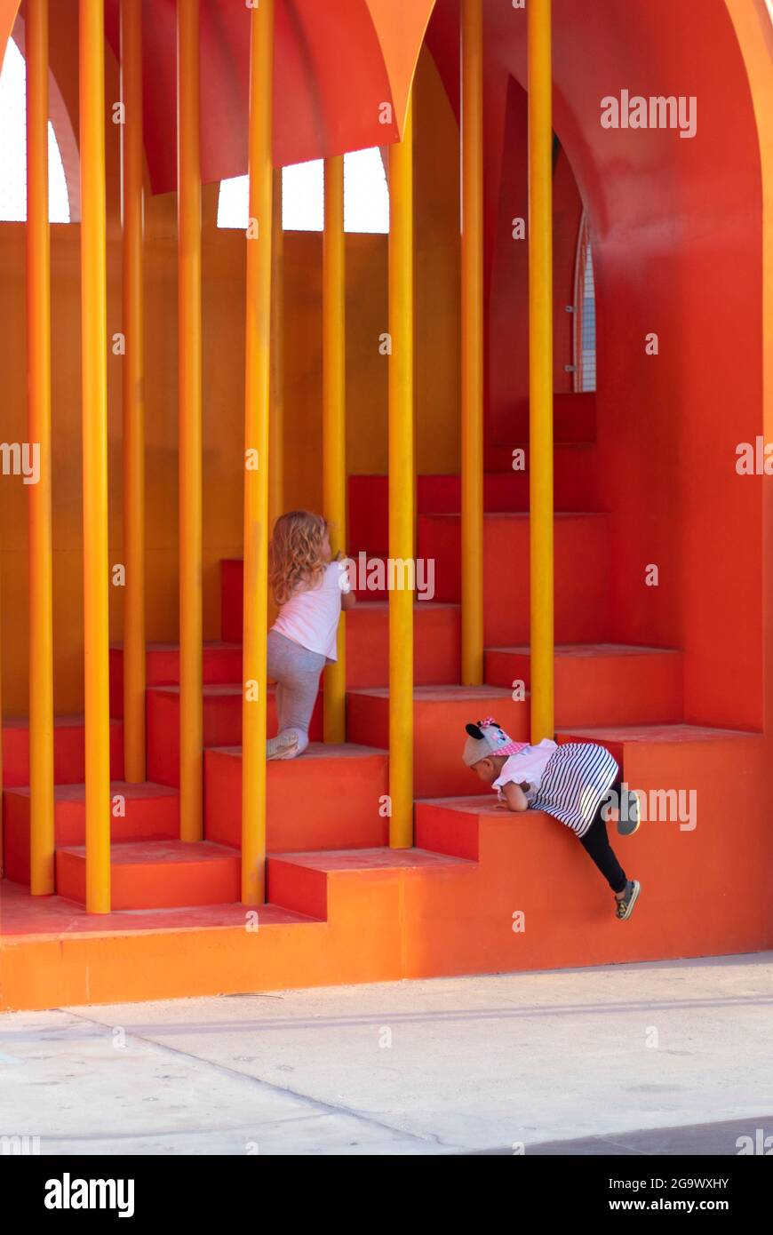 Little girls climbing steps in the playground Stock Photo - Alamy
