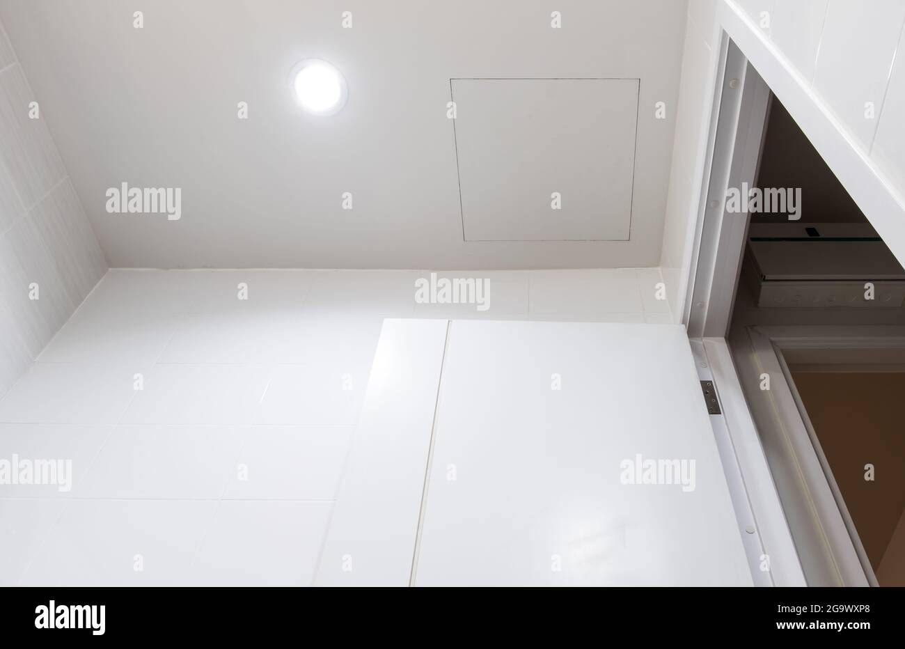 The access door on the white ceiling in the bathroom for maintenance of ...