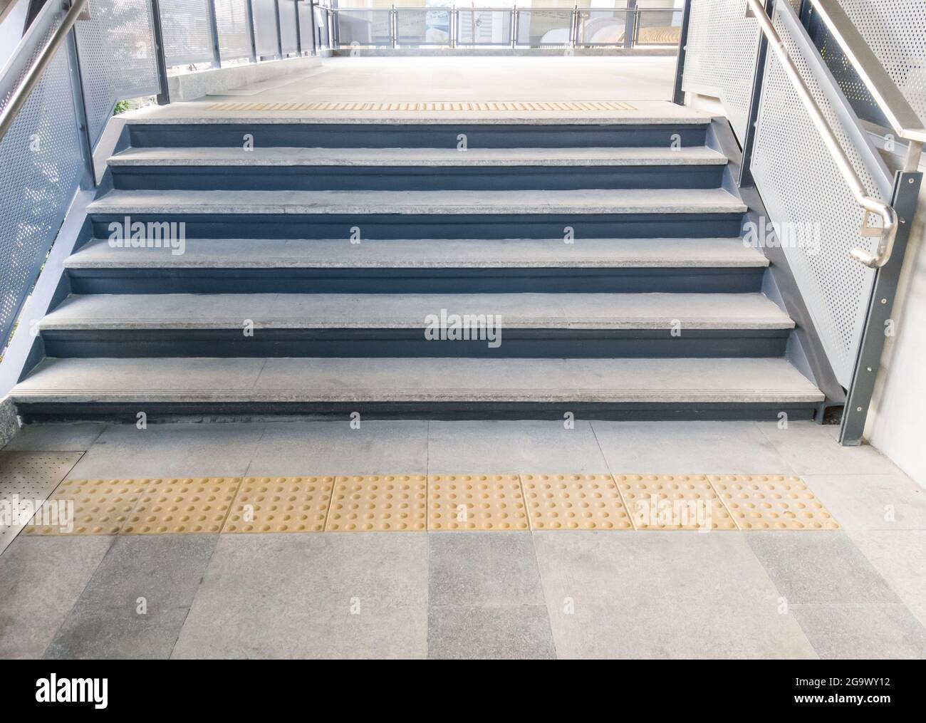 The modern staircase with the metal railing in the walkway bridge to ...