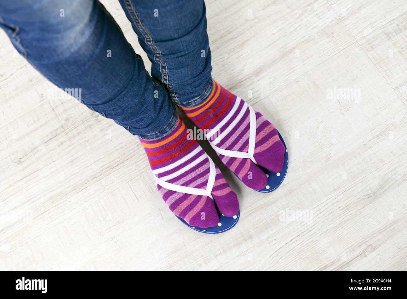Female feet in socks with pink flip-flops, on floor background Stock ...