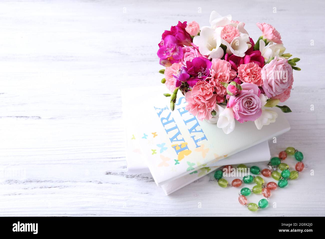 Beautiful fresh spring flowers with stack of books, top view Stock ...