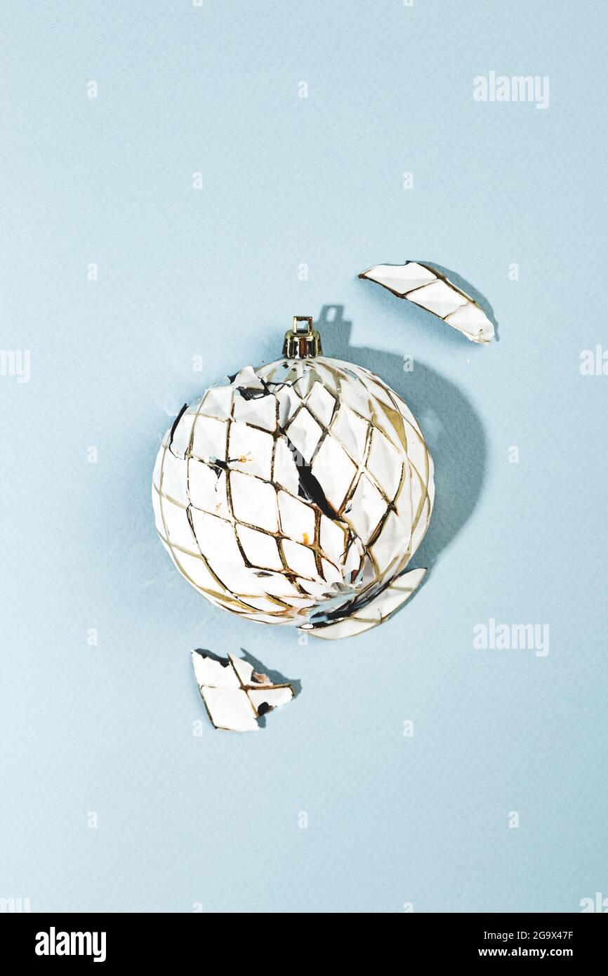 White Christmas ball with shattered or broken shell on blue background ...