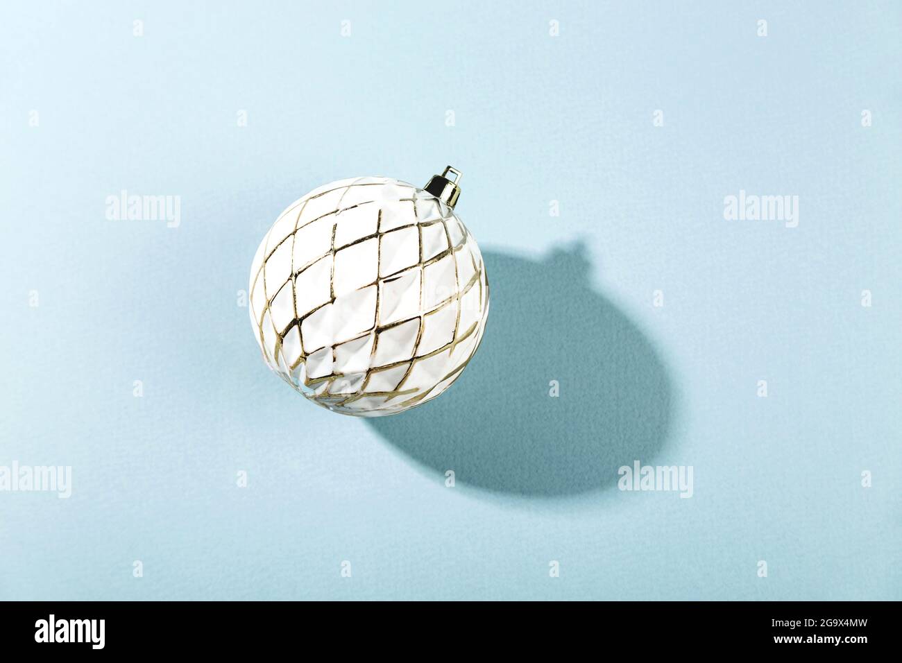 Minimalistic Christmas composition. One white Christmas ball on blue ...