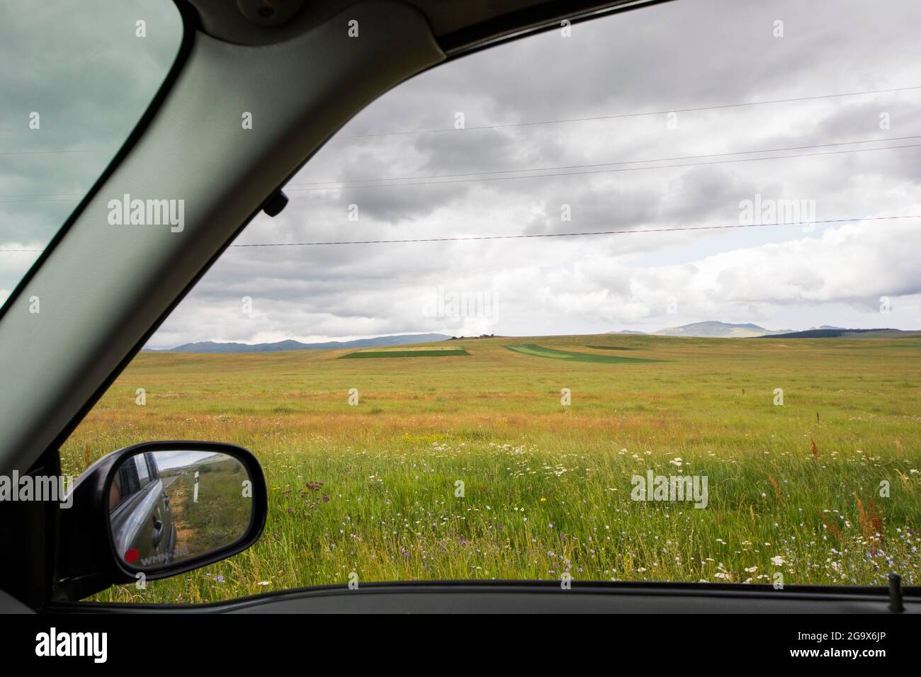 Car mirror and highway view, black car and nature landscape in Georgia ...