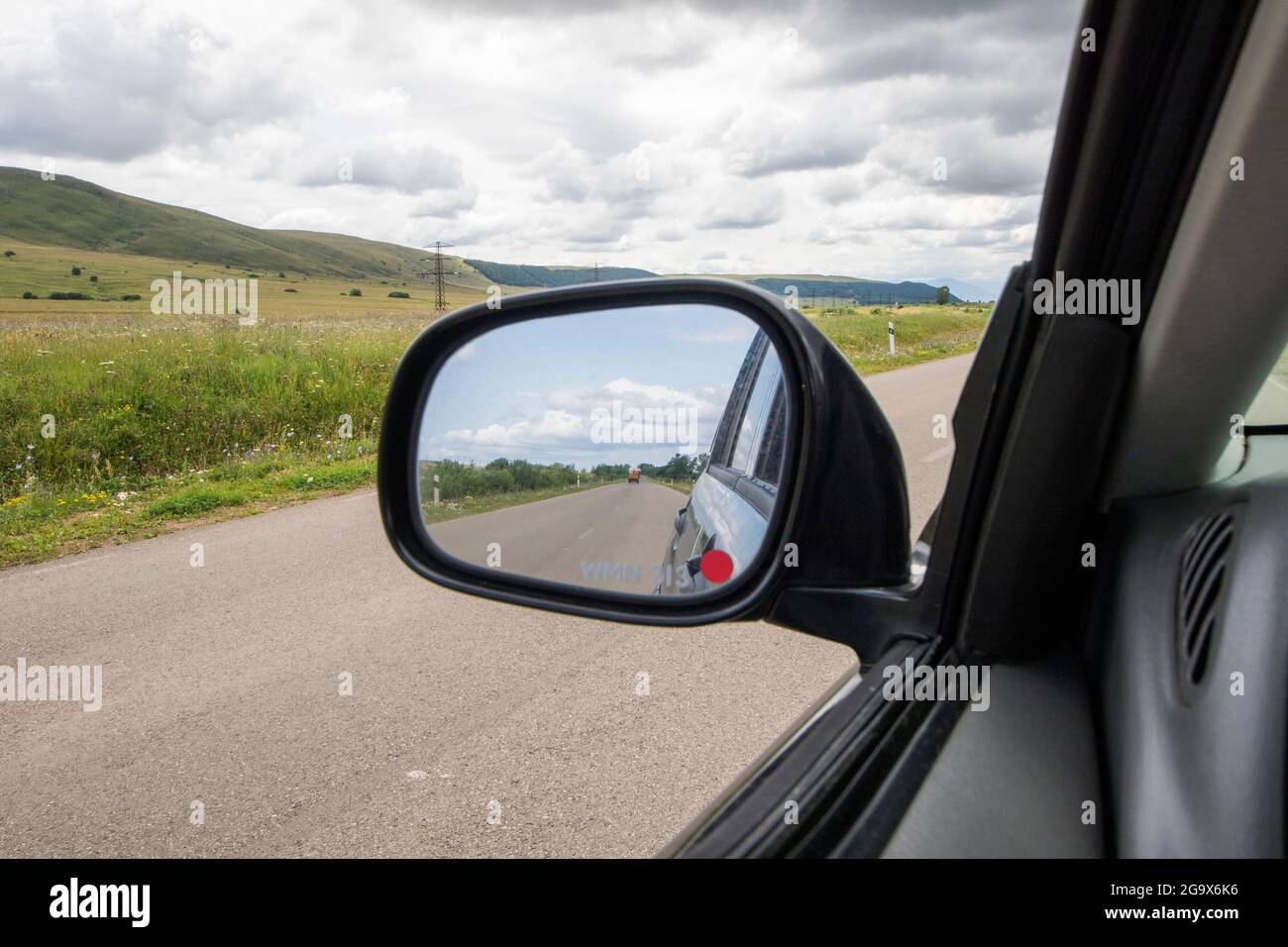 Car mirror and highway view, black car and nature landscape in Georgia ...