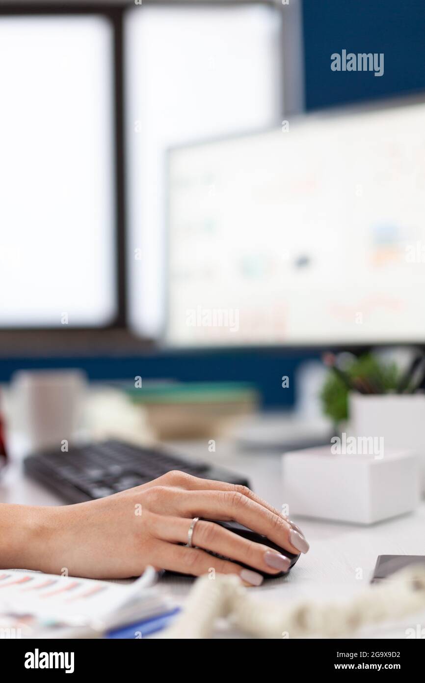 Company executive in his office using and clicking on mouse with ...