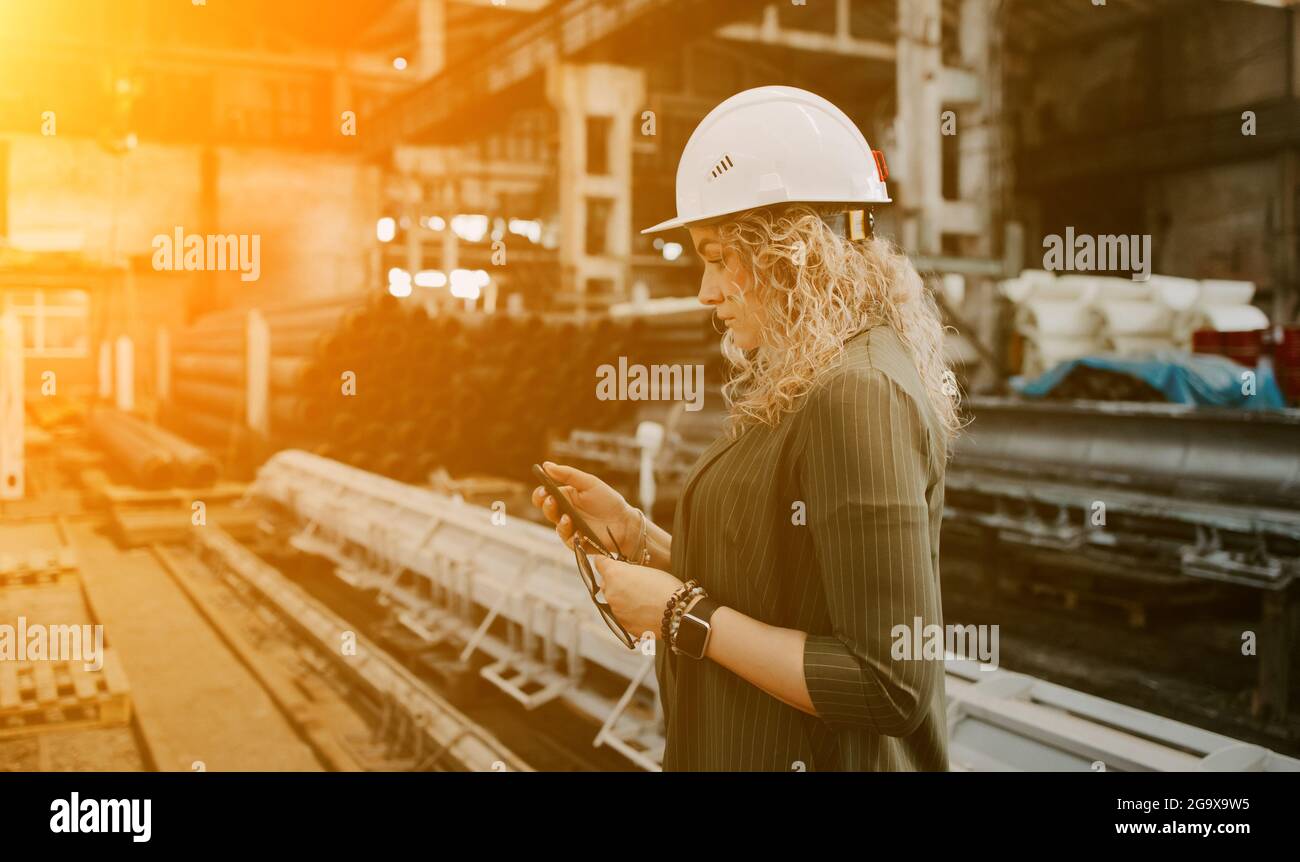 beautiful female engineer stands and takes pictures of the plant Stock ...