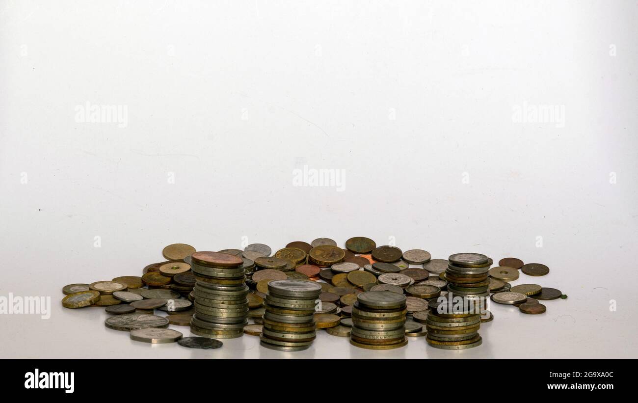 photo with metal coins of different shapes, countries and values, white ...