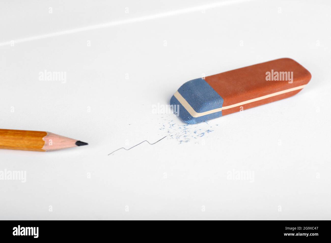 Eraser and pencil on paper background Stock Photo - Alamy
