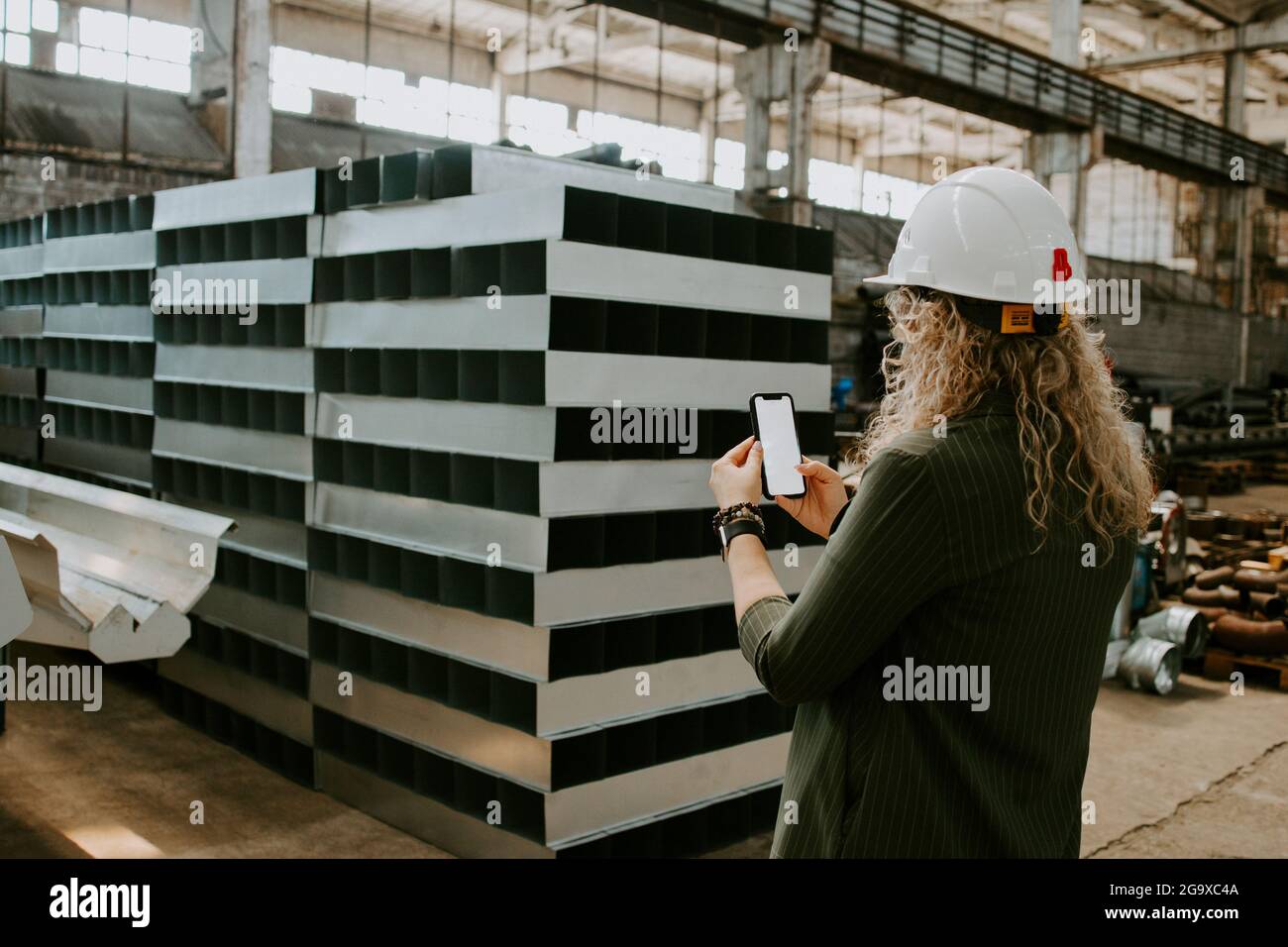 beautiful female engineer stands and takes pictures of the plant Stock ...
