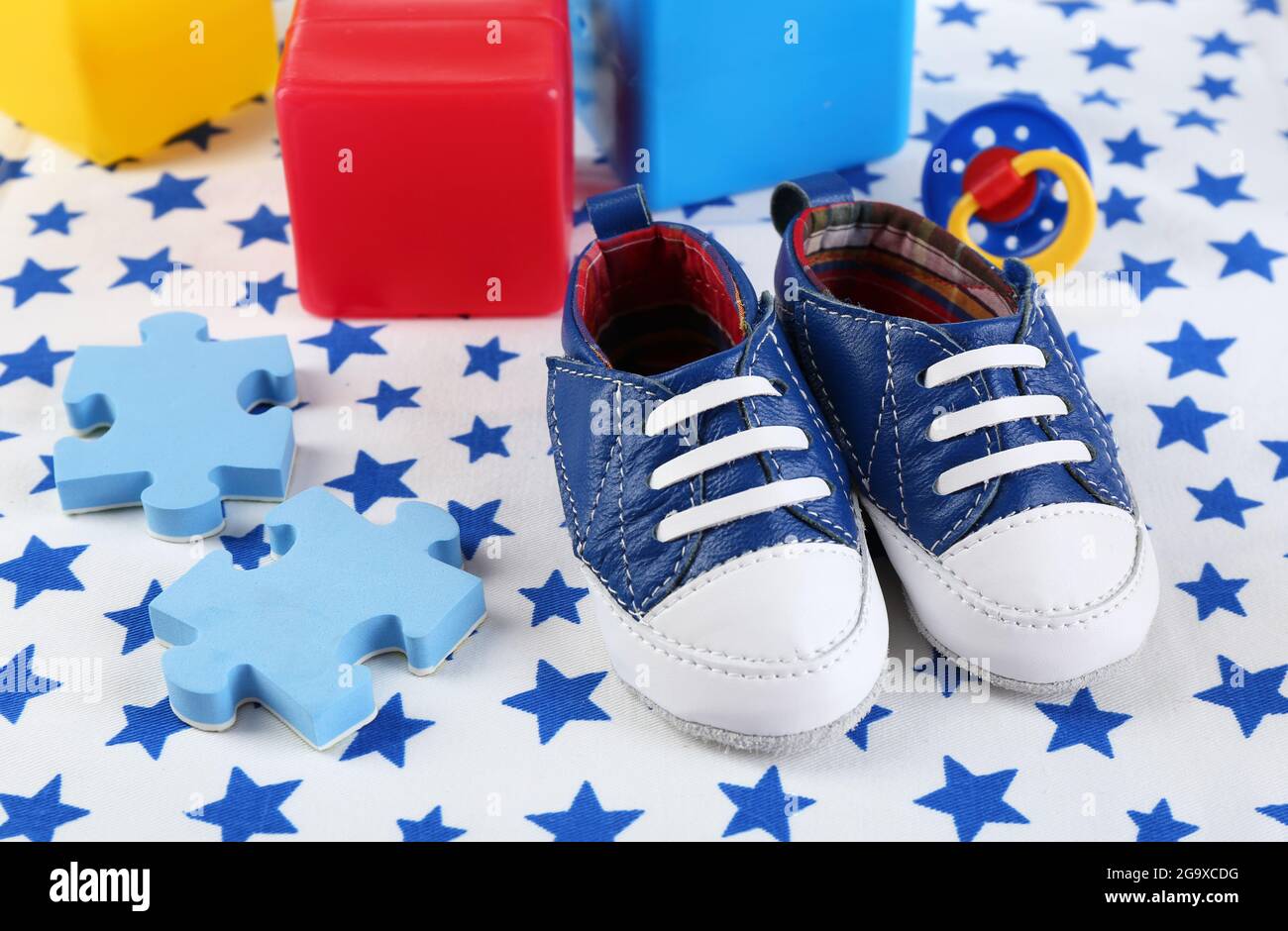 Baby shoes on cloth background Stock Photo - Alamy