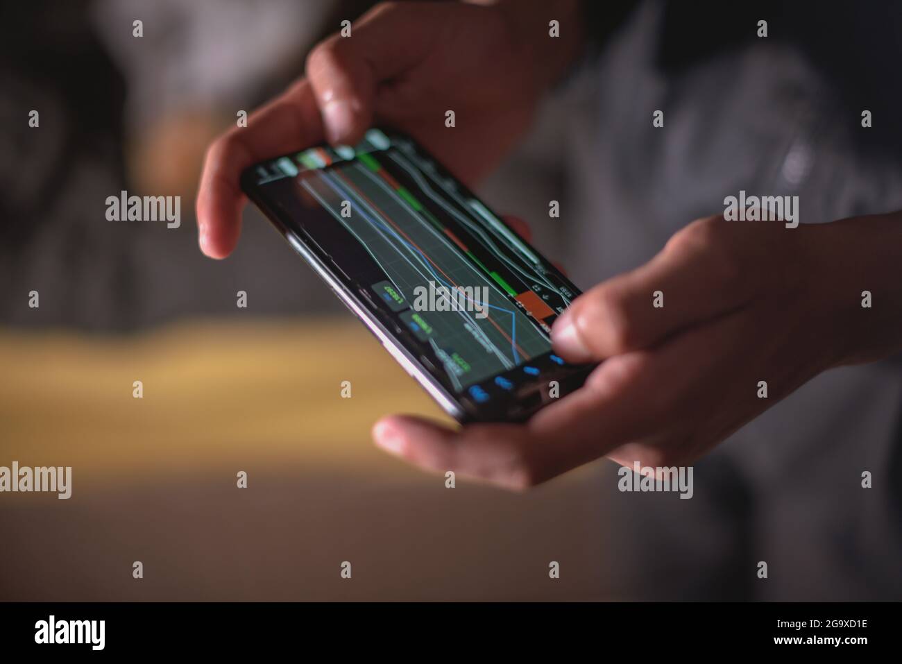 Person seen using mobile phone to trade Stock Photo - Alamy