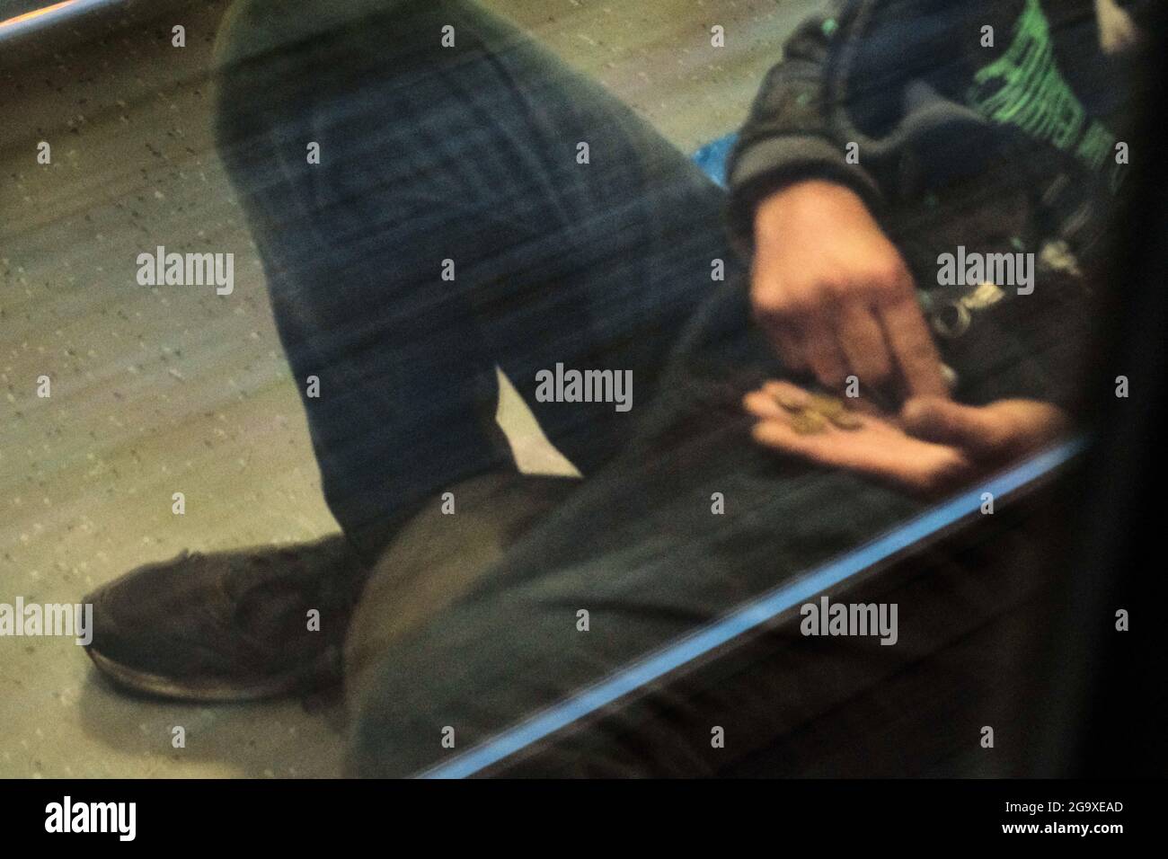 Berlin, Germany. 24th July, 2021. A homeless man sits on the floor of a ...