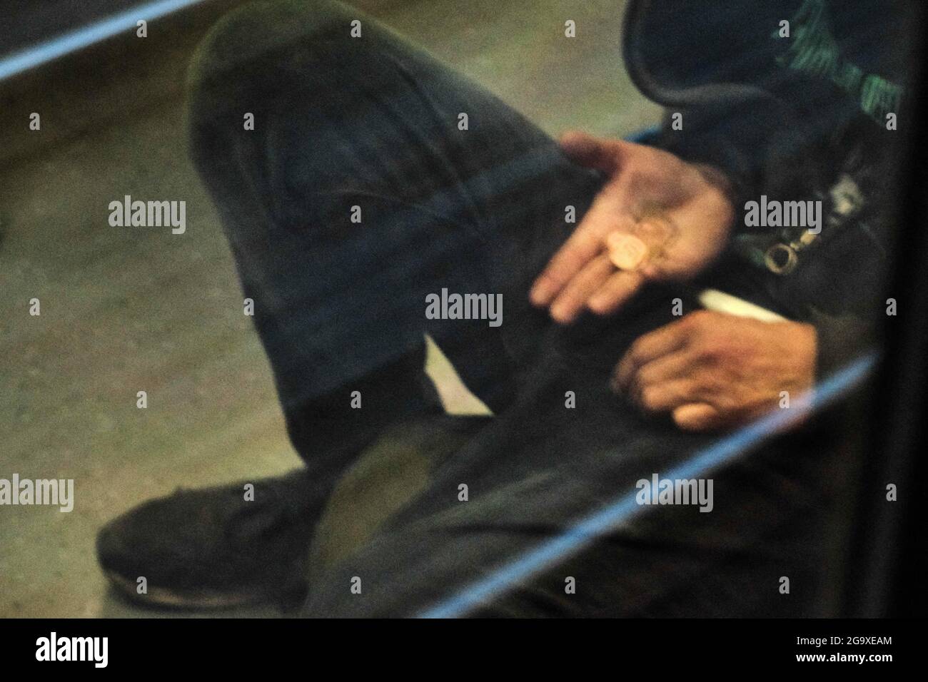 Berlin, Germany. 24th July, 2021. A homeless man sits on the floor of a ...